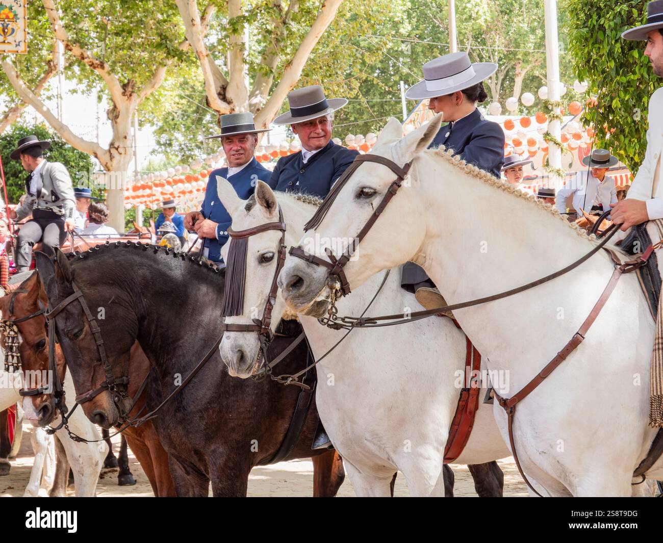 Group of Spanish riders in traditional attire on horseback at an ...