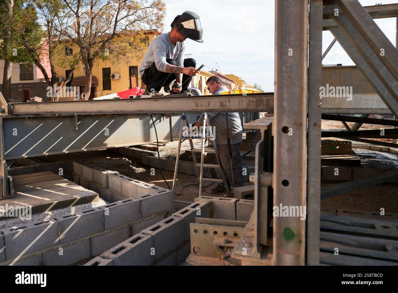Welder and skilled worker during installation of MABEY temporary bridge ...