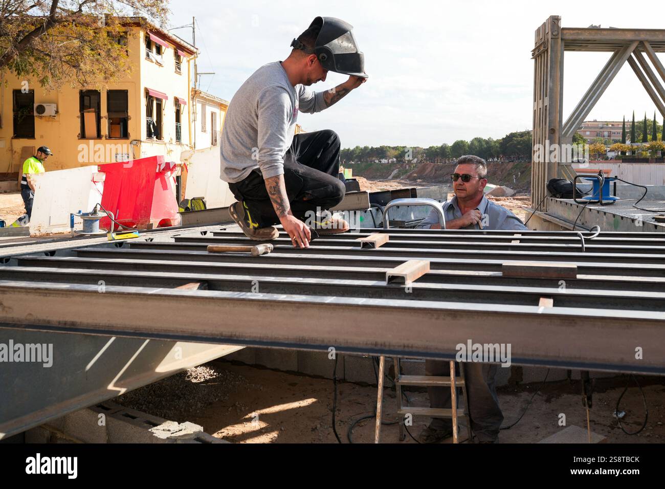 Welder and skilled worker during installation of MABEY temporary bridge ...