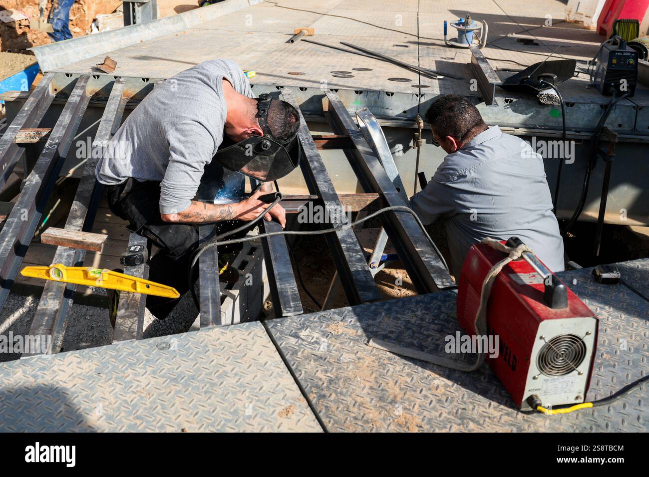 Welder and skilled worker during installation of MABEY temporary bridge ...