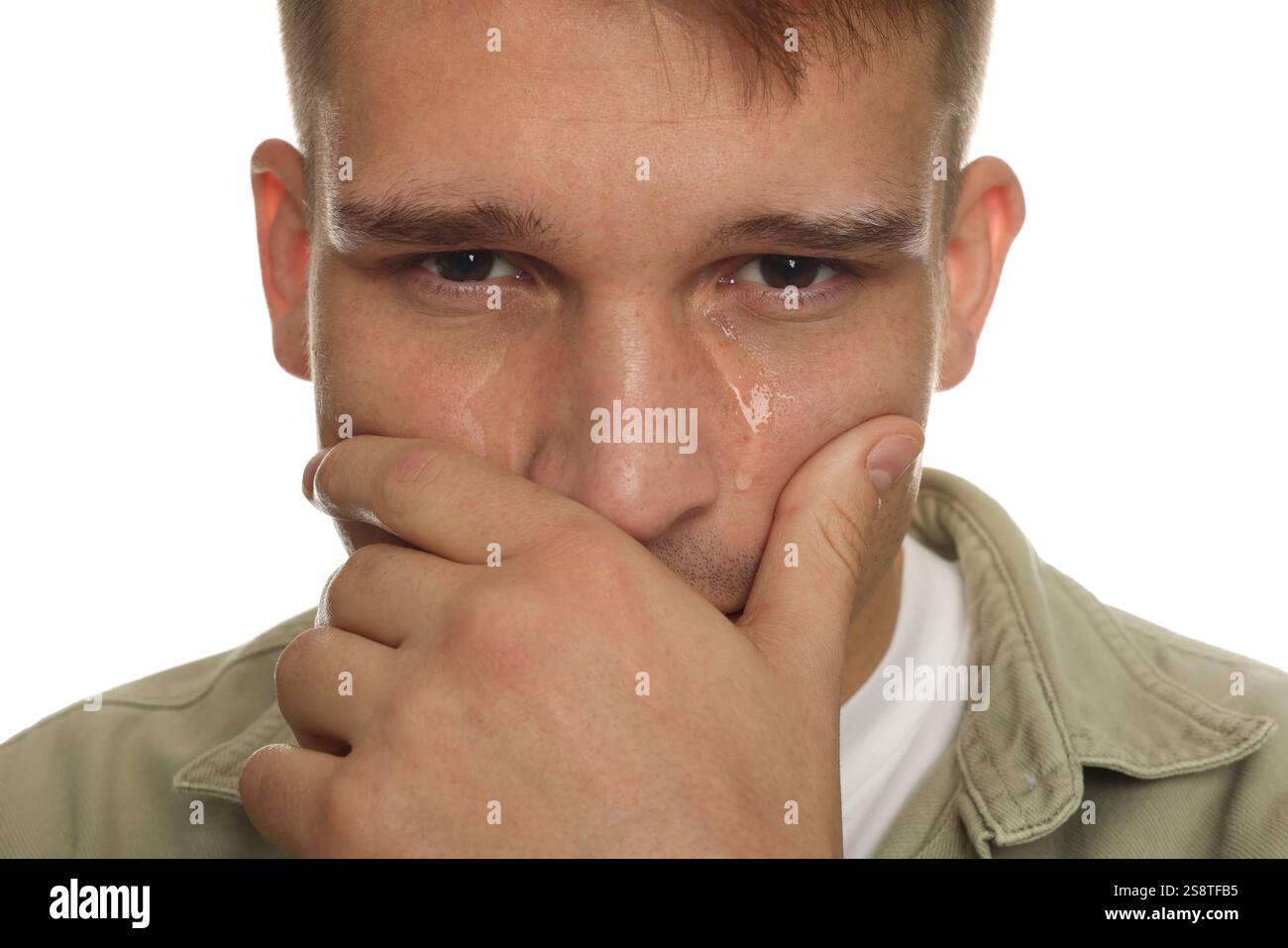 Distressed young man crying on white background Stock Photo - Alamy