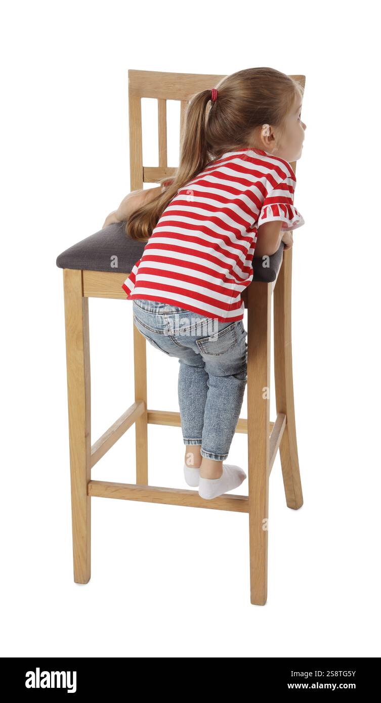 Little girl standing on stool against white background, back view Stock ...