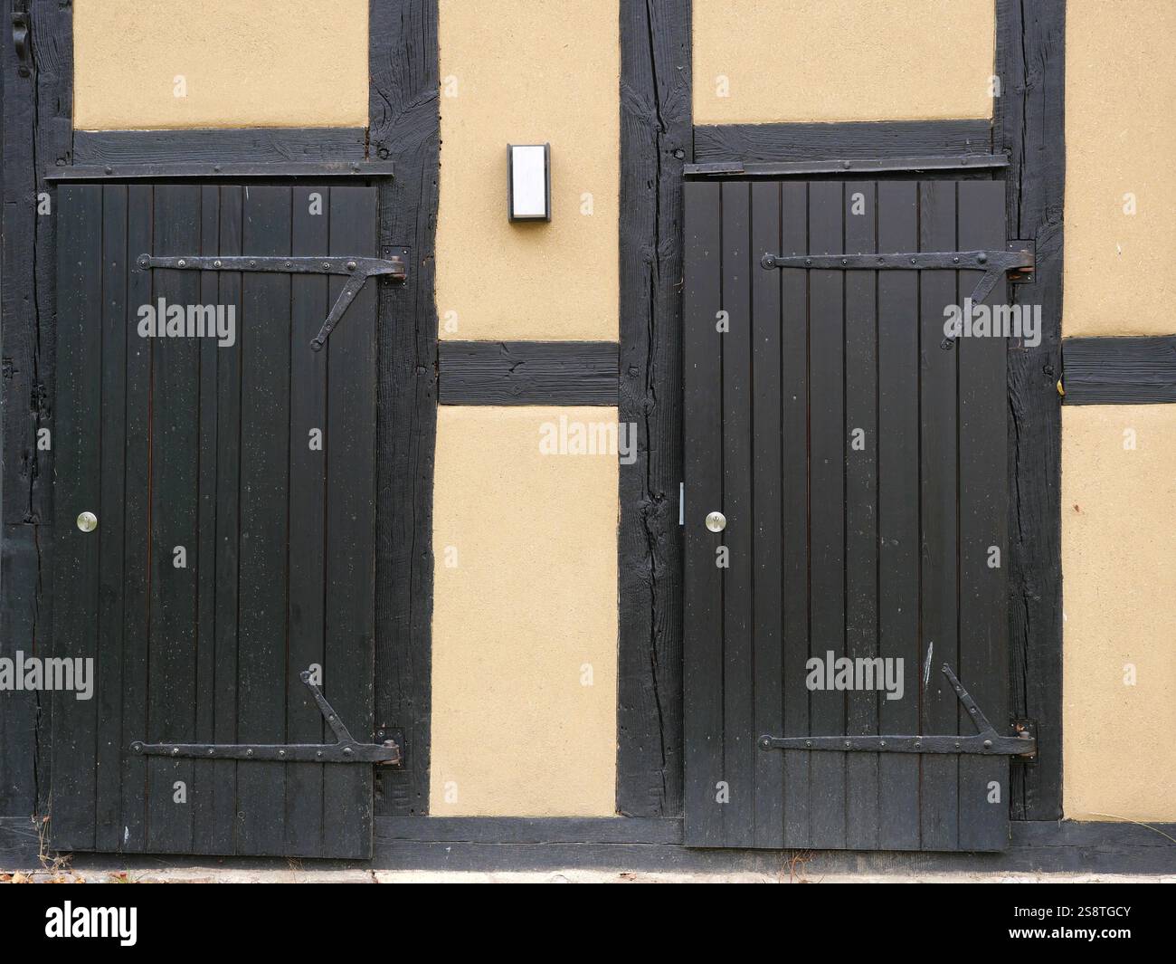 Wooden door on a half-timbered barn. The door fittings and the deep ...
