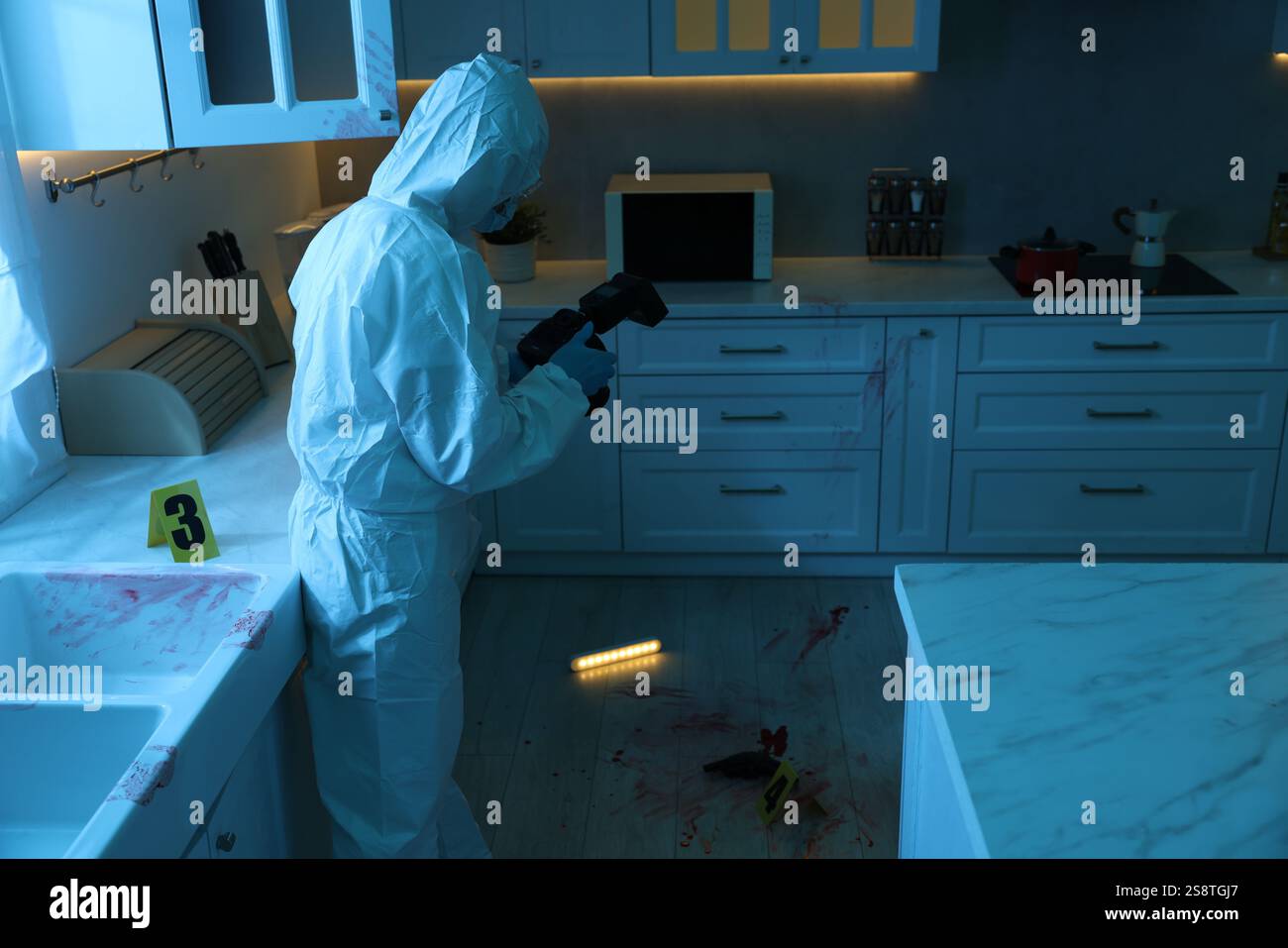 Forensic expert with camera working at crime scene in dark room Stock ...