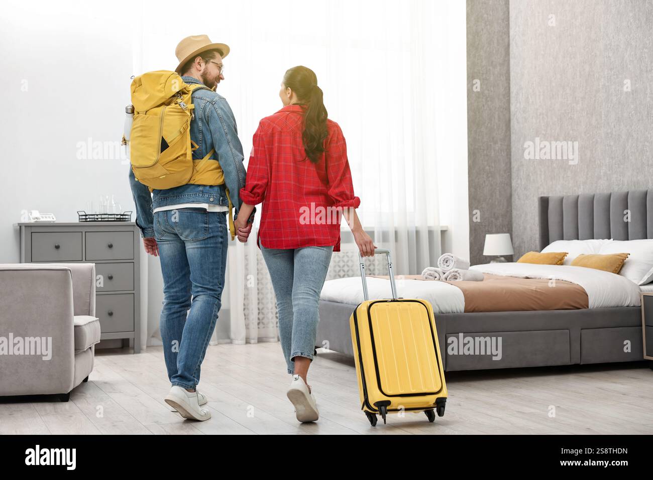 Travellers with suitcase and backpack in hotel room, back view Stock ...