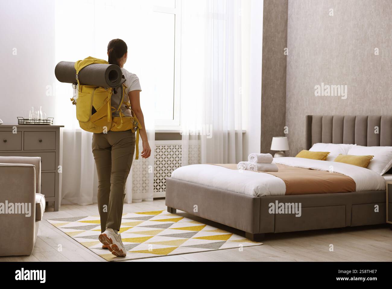 Traveller with backpack in hotel room, back view Stock Photo - Alamy