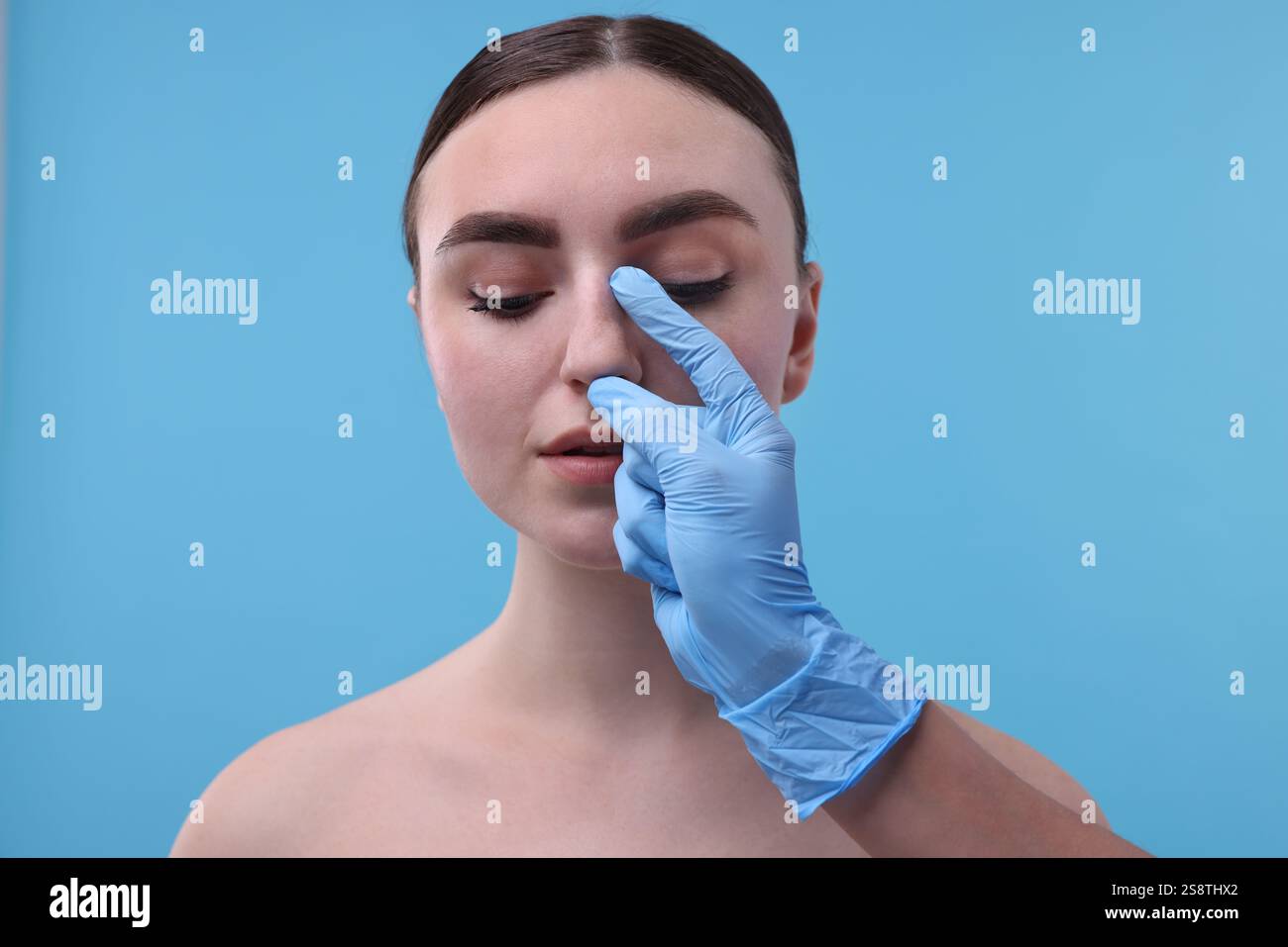 Doctor checking patient's nose before plastic surgery operation on ...