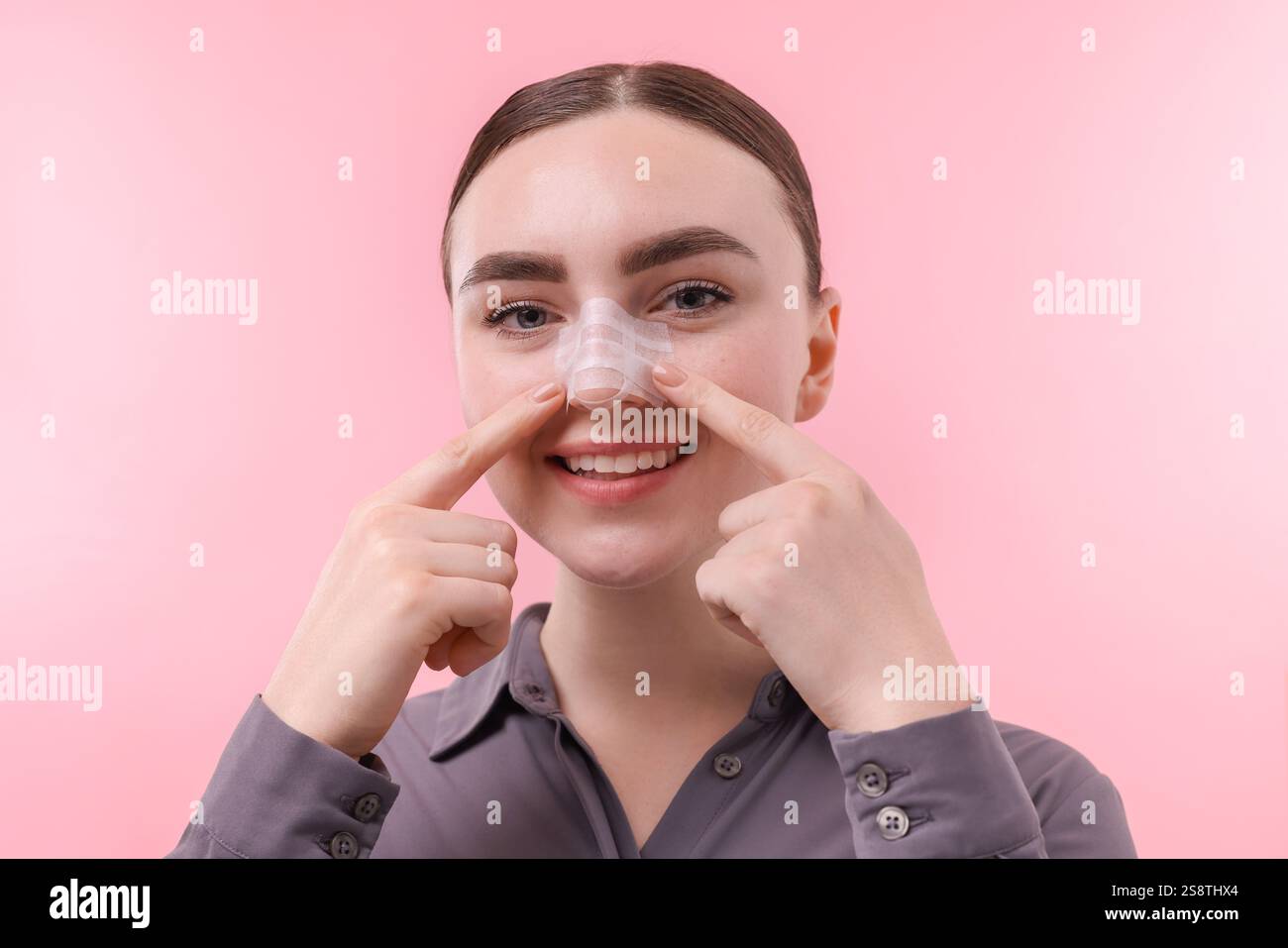 Woman with medical bandage on her nose after plastic surgery operation ...