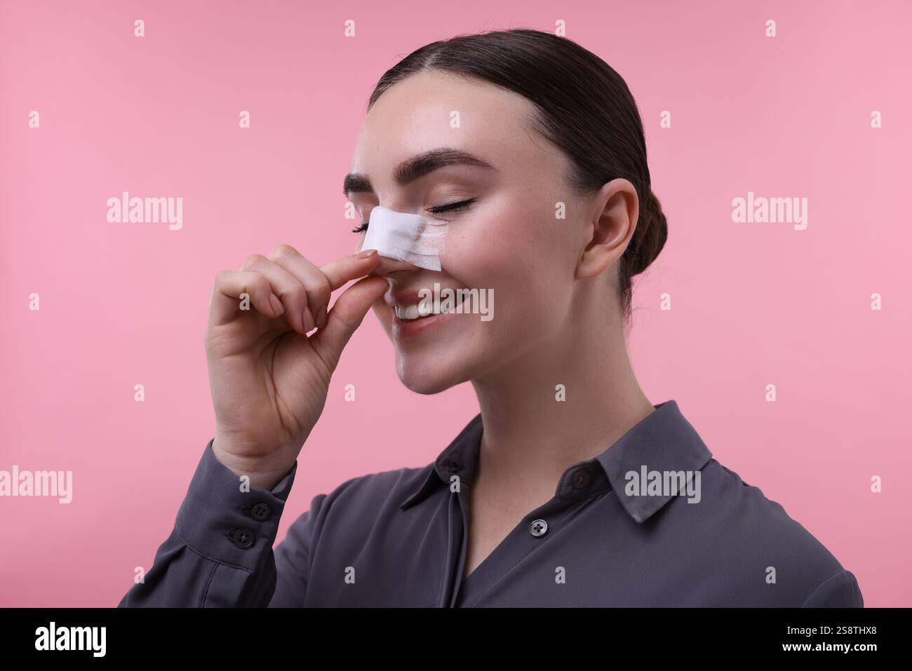 Woman with medical bandage on her nose after plastic surgery operation ...