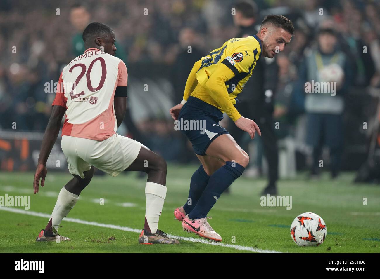 Fenerbahce's Dusan Tadic, right, and Lyon's Sael Kumbedi fight for the ...
