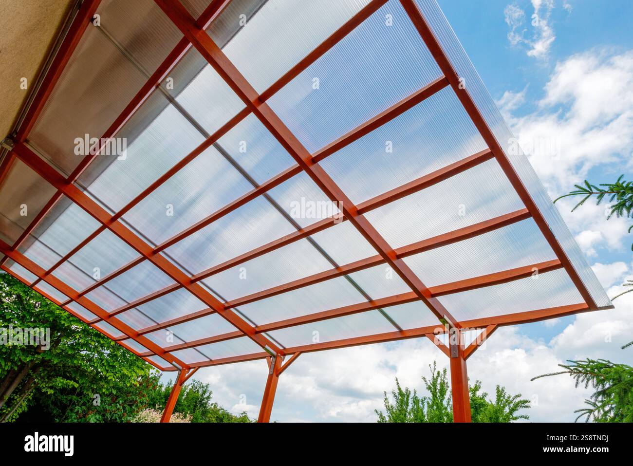 Transparent polycarbonate roof on a modern wooden pergola structure in ...