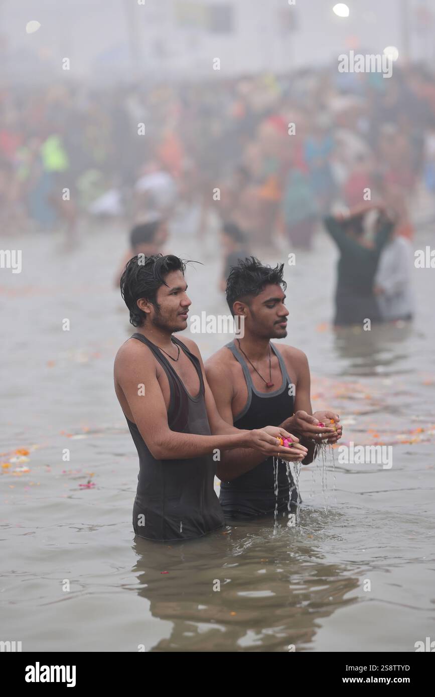 Pilgrims bathing in the early morning at the Triveni Sangam on the ...