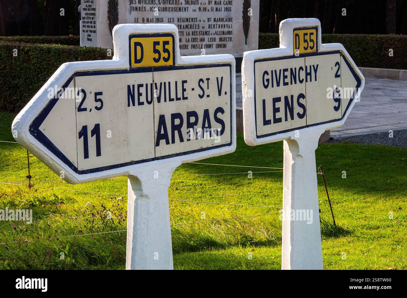 Two directional road signs, likely from World War I, mark the distances ...