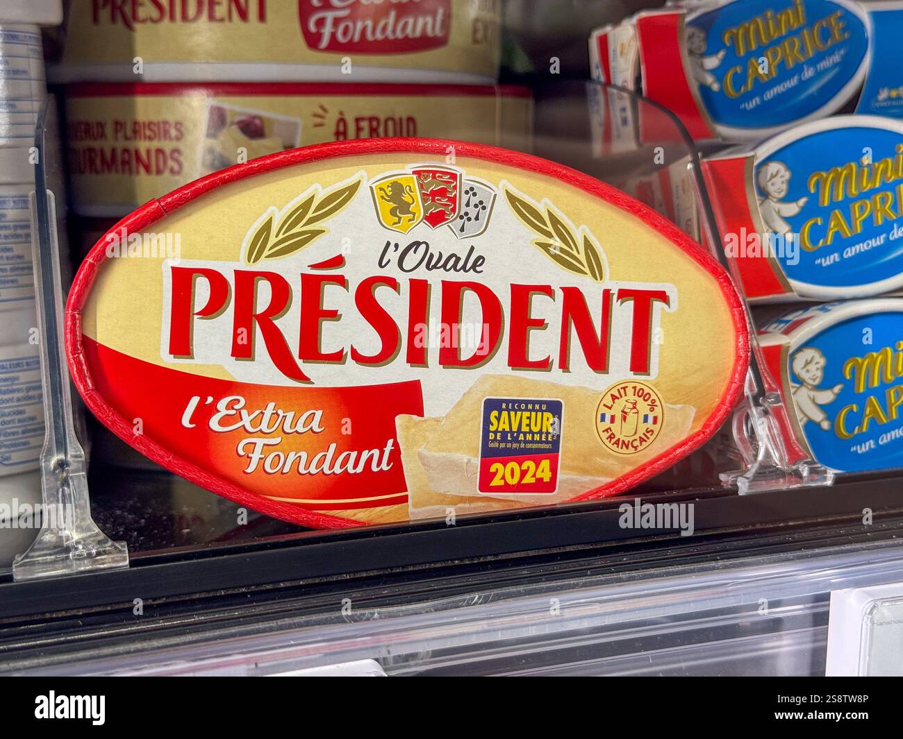 Creamy cheese spread on display in a local market refrigerator aisle ...