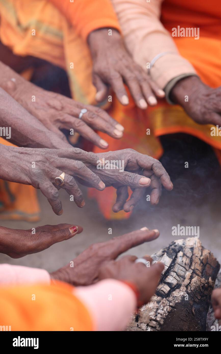 Pilgrims warming their hands during a cold morning, Maha Kumbh Mela ...