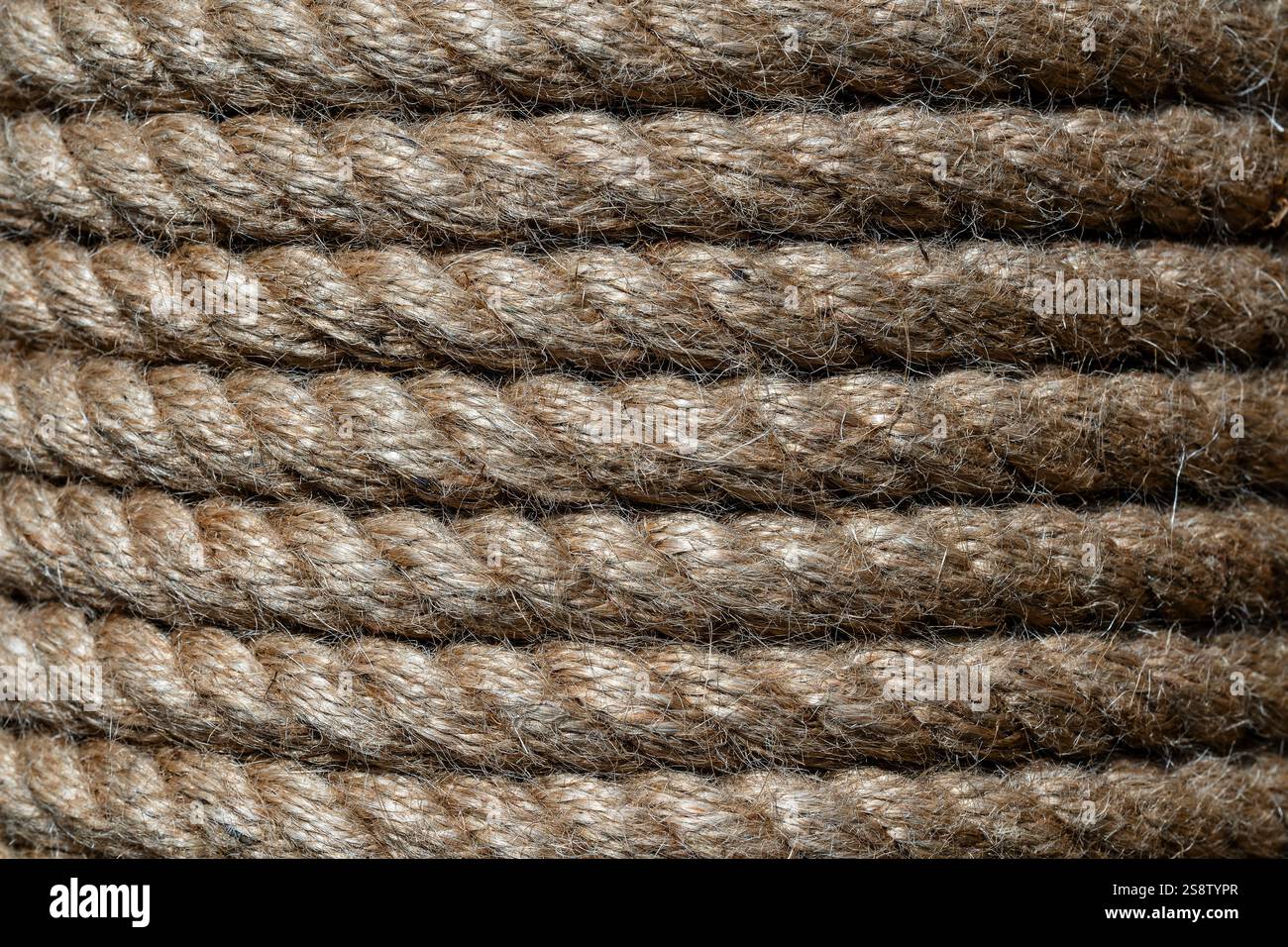 Natural jute hemp rope rolled into a coil, close up. Brown spool of ...