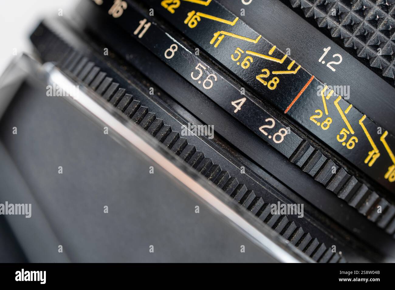 An old camera lens close up. The lens, focus and exposure controls of a ...