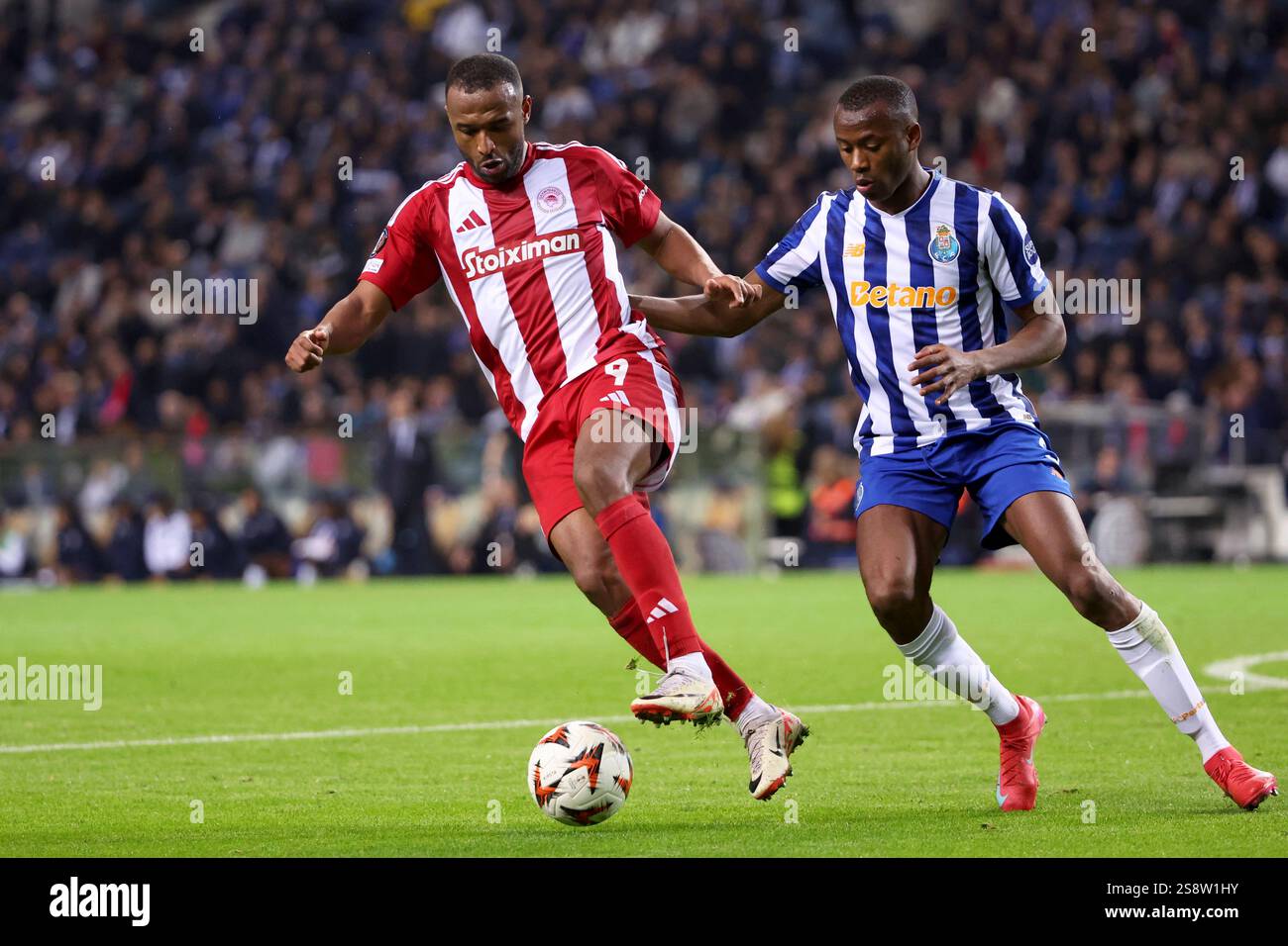 Olympiacos' Ayoub El Kaabi controls the ball next to Porto's Tiago ...