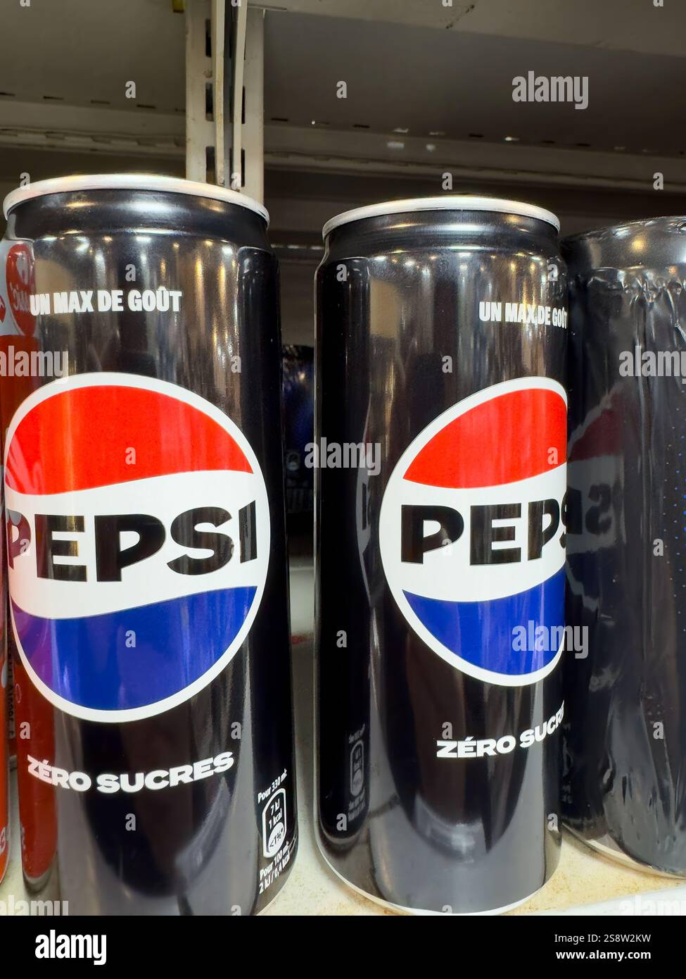 Popular soda cans displayed in a store aisle in bright packaging Stock ...