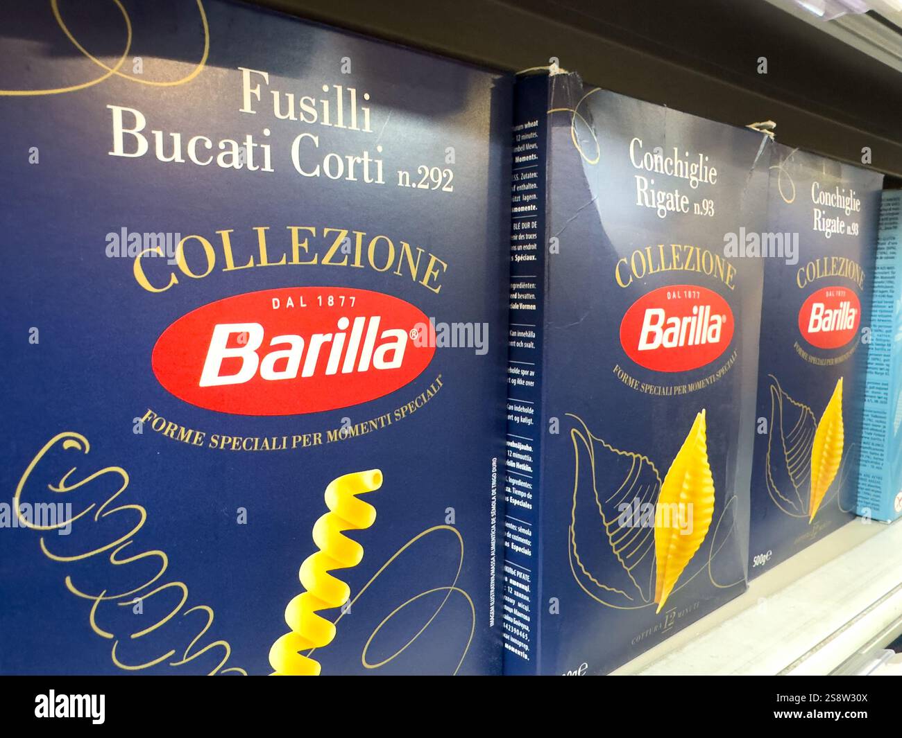 Various types of pasta boxes on display in a grocery store Stock Photo ...