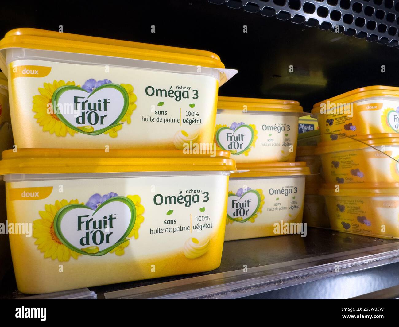 Butter alternatives displayed on a grocery store shelf in bright ...