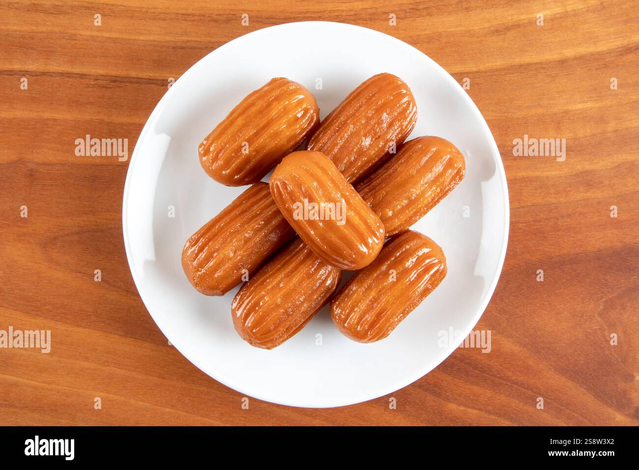 Traditional Turkish dessert Tulumba on a plate. Tulumba dessert is ...