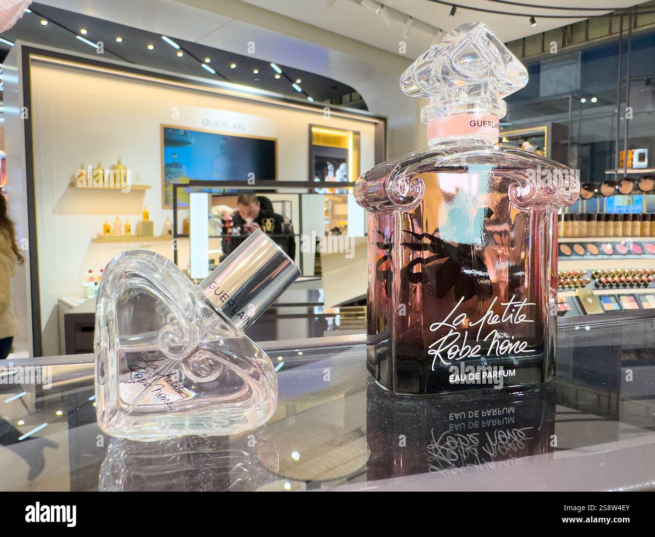 Elegant perfume bottles displayed in a modern retail shop interior ...