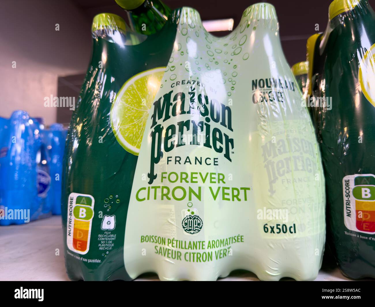 Refreshing sparkling water packs with lime flavor on store shelf Stock ...