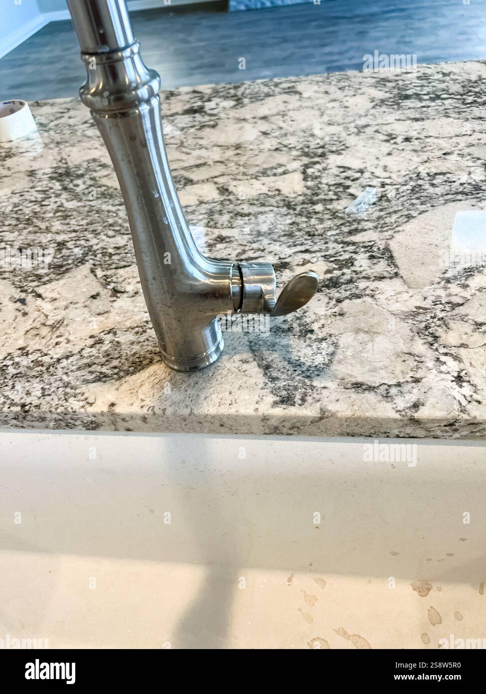 Kitchen faucet installed on granite countertop Stock Photo - Alamy