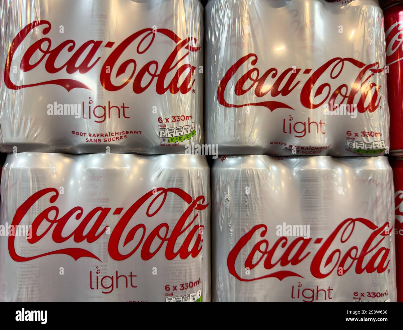 Six pack of light soda displayed in a store aisle with bright packaging ...