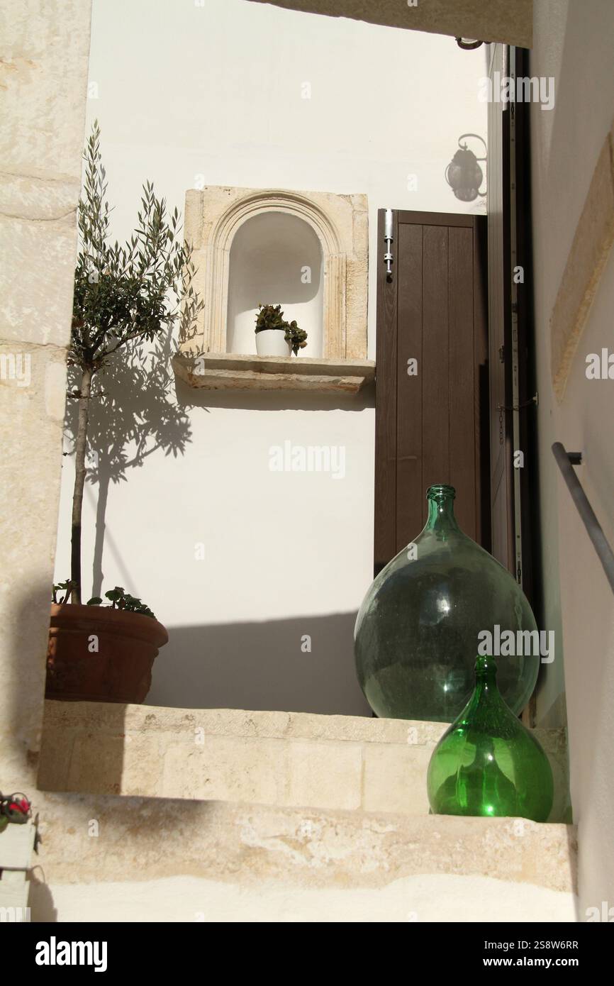 Noci, Italy. Italian demijohn vases on the steps of a building in the ...