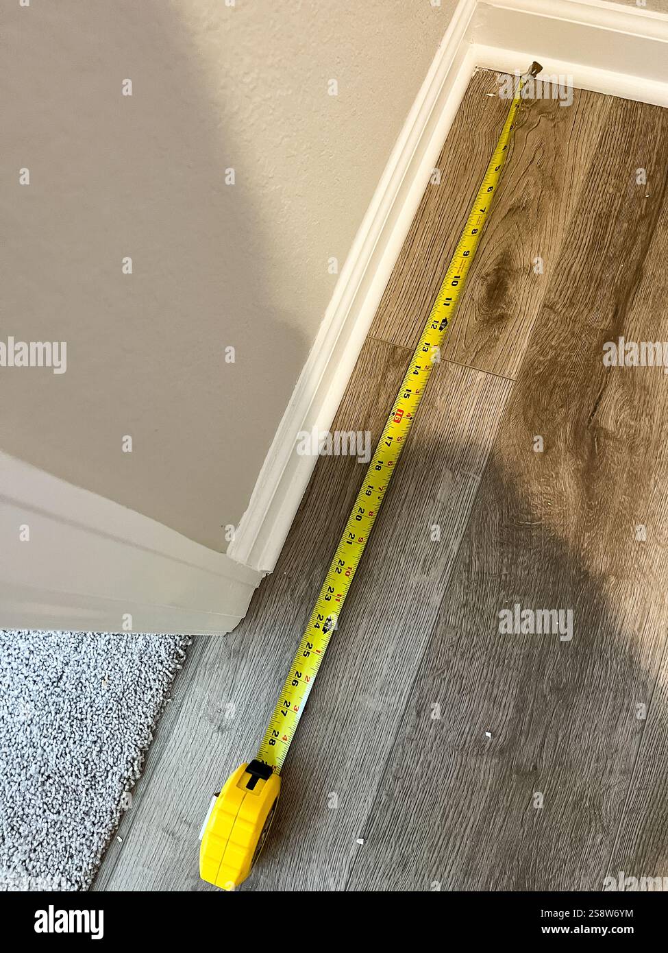 Measuring Wall Dimensions Near Door in New Home Stock Photo - Alamy
