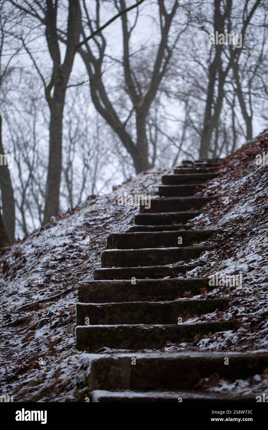Weathered concrete steps leading up a hill, symbolizing human ...