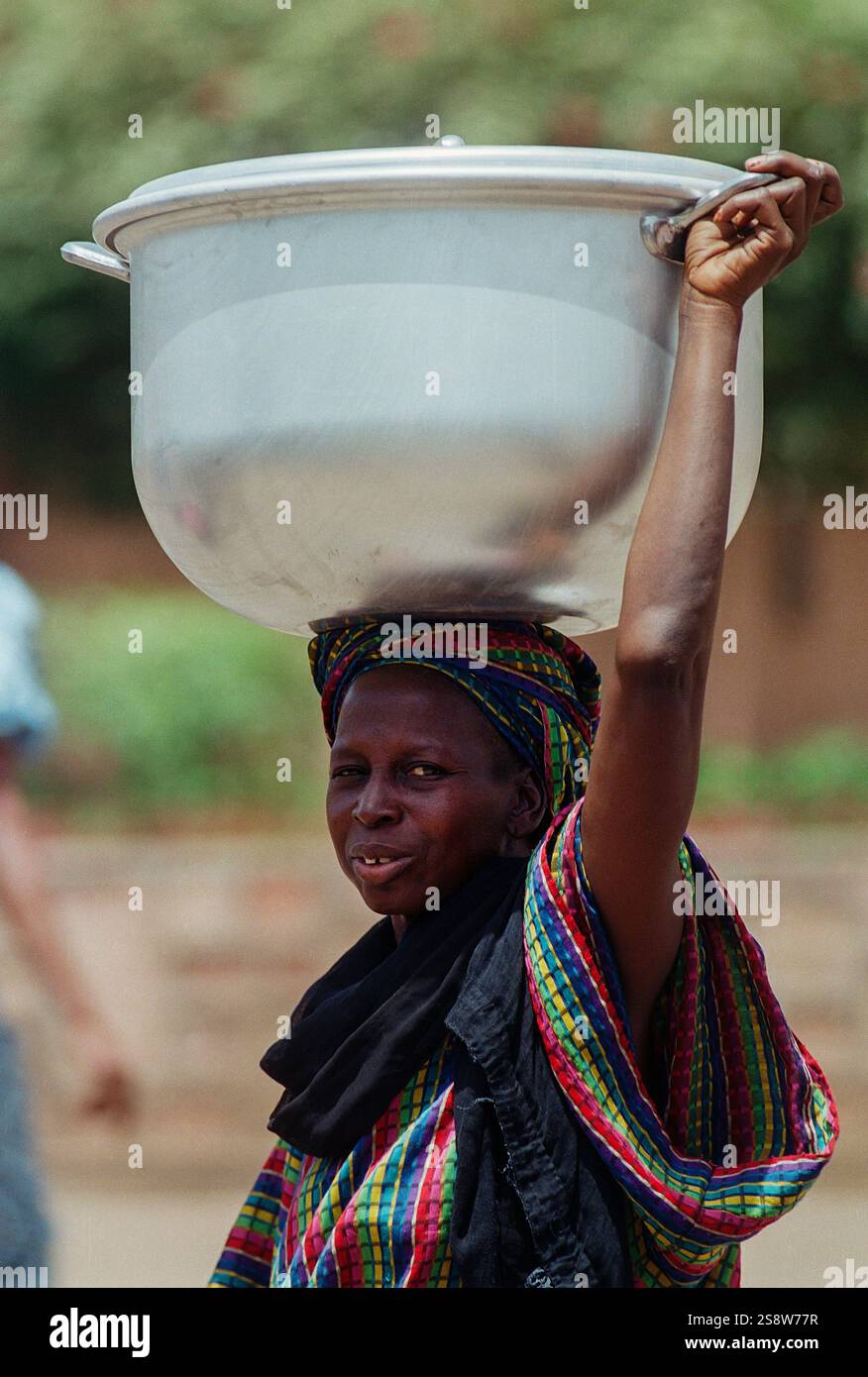 Women carrying provisions in the slums of Bamako scattered throughout ...