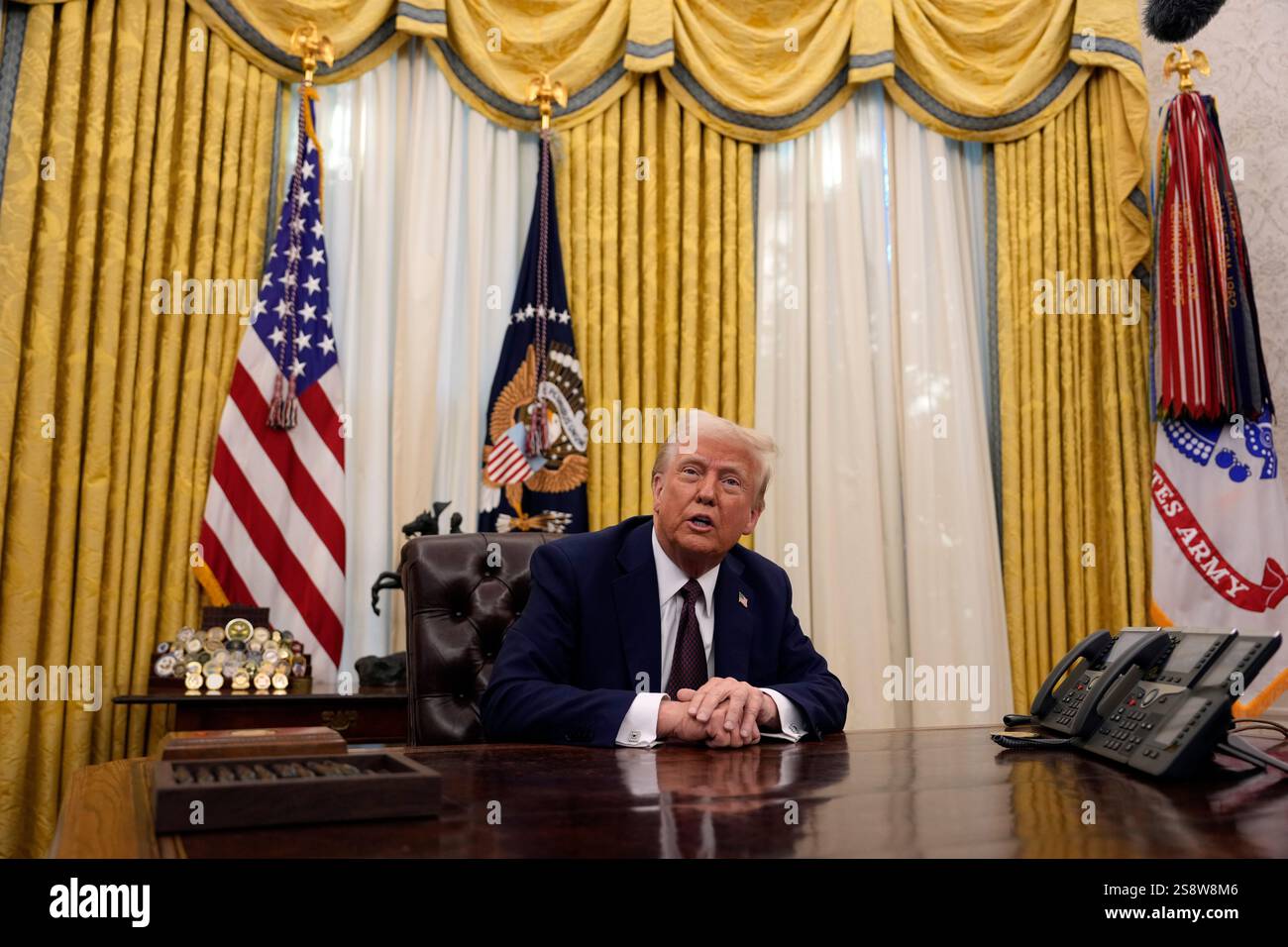 President Donald Trump answers questions from reporters as he signs an ...