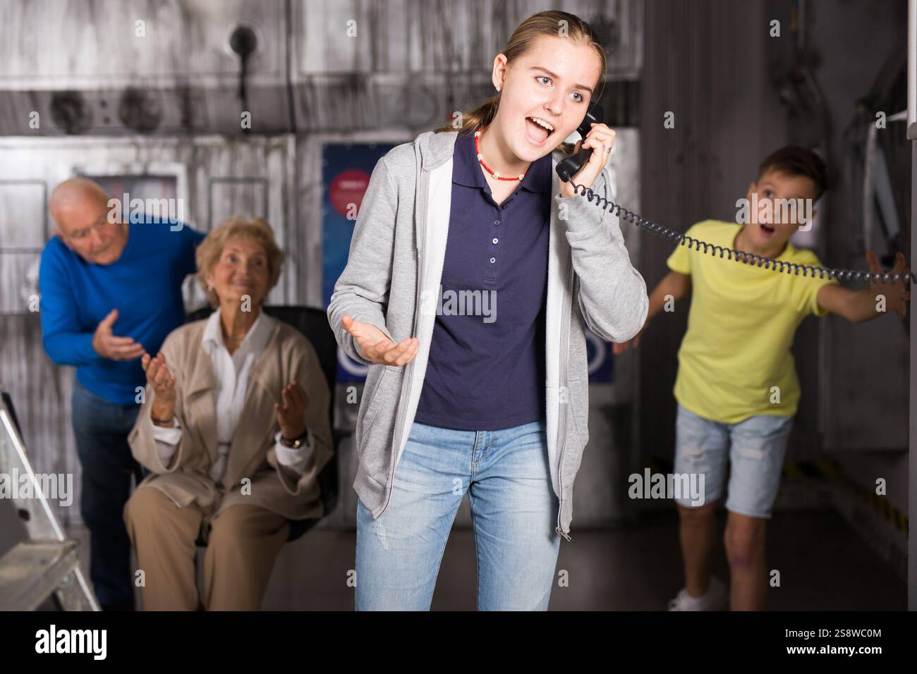Scared girl shouts into telephone receiver Stock Photo - Alamy