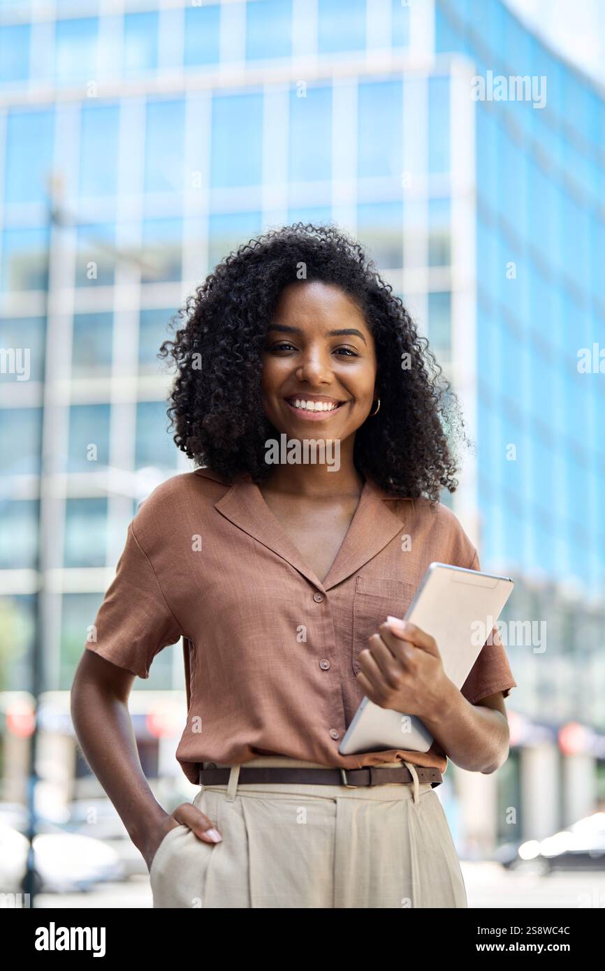 Vertical portrait of happy young African American professional woman ...