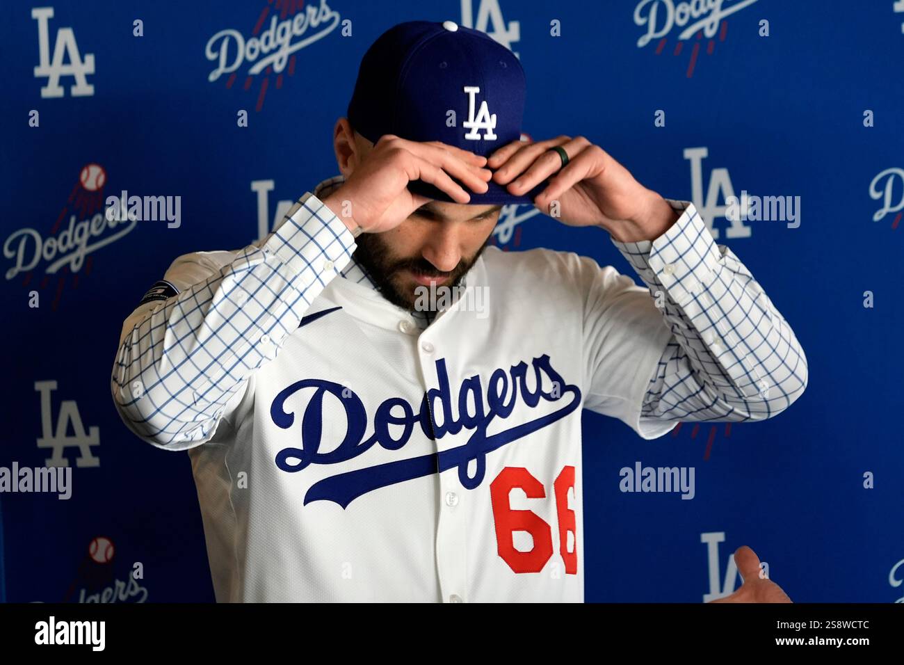 Left-handed new reliever Tanner Scott dons his new cap and jersey ...