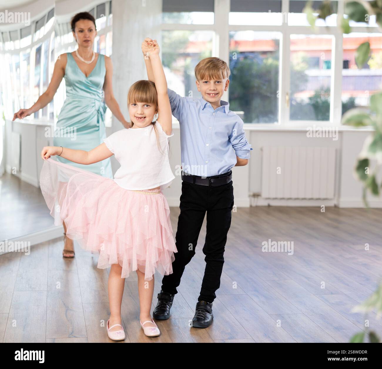 Boy and girl in pair train to dance contemporary vigorous waltz during ...