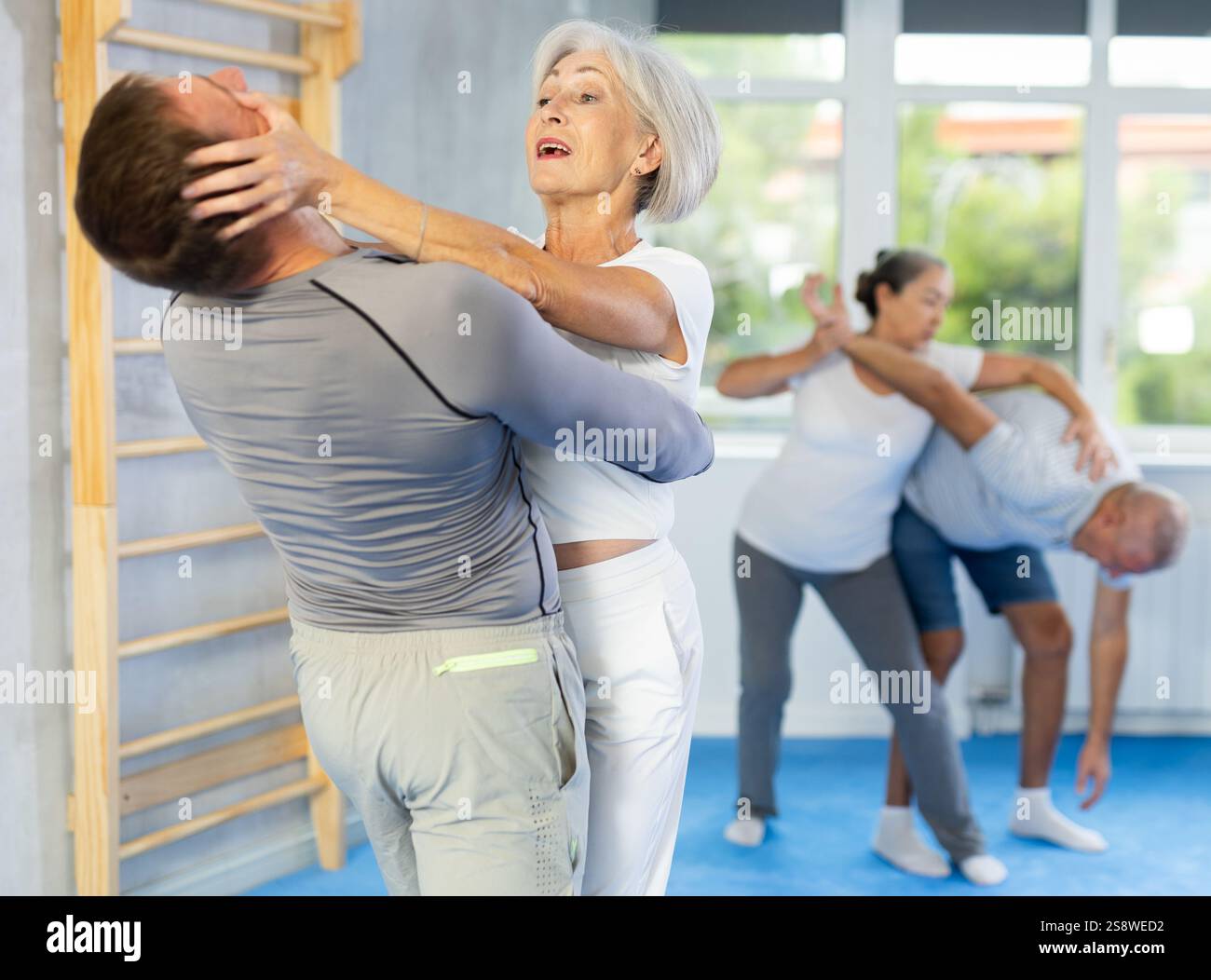 Old woman practicing self-defense techniques in pairs Stock Photo - Alamy