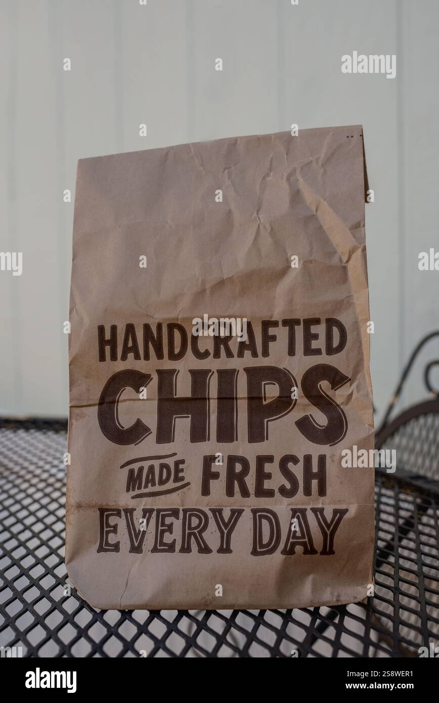 Wrinkled brown paper bag with the words Handcrafted Chips Made Fresh ...