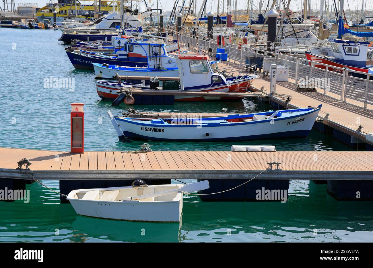 Traditional fishing boats moored in the harbour at Corralejo ...