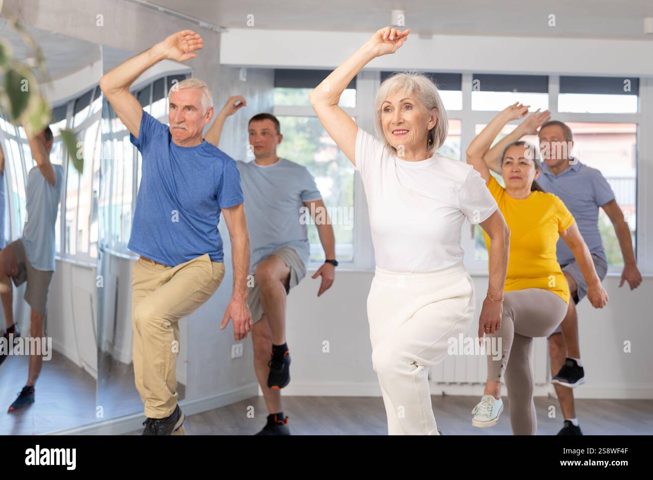 Elderly woman dances modern dances in group Stock Photo - Alamy