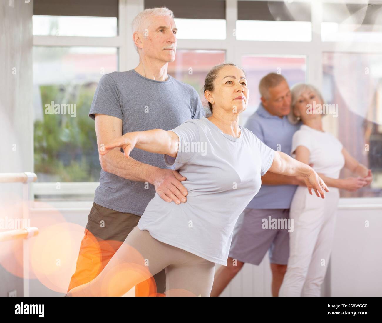 Mature female ballerina and old male partner practicing ballet ...