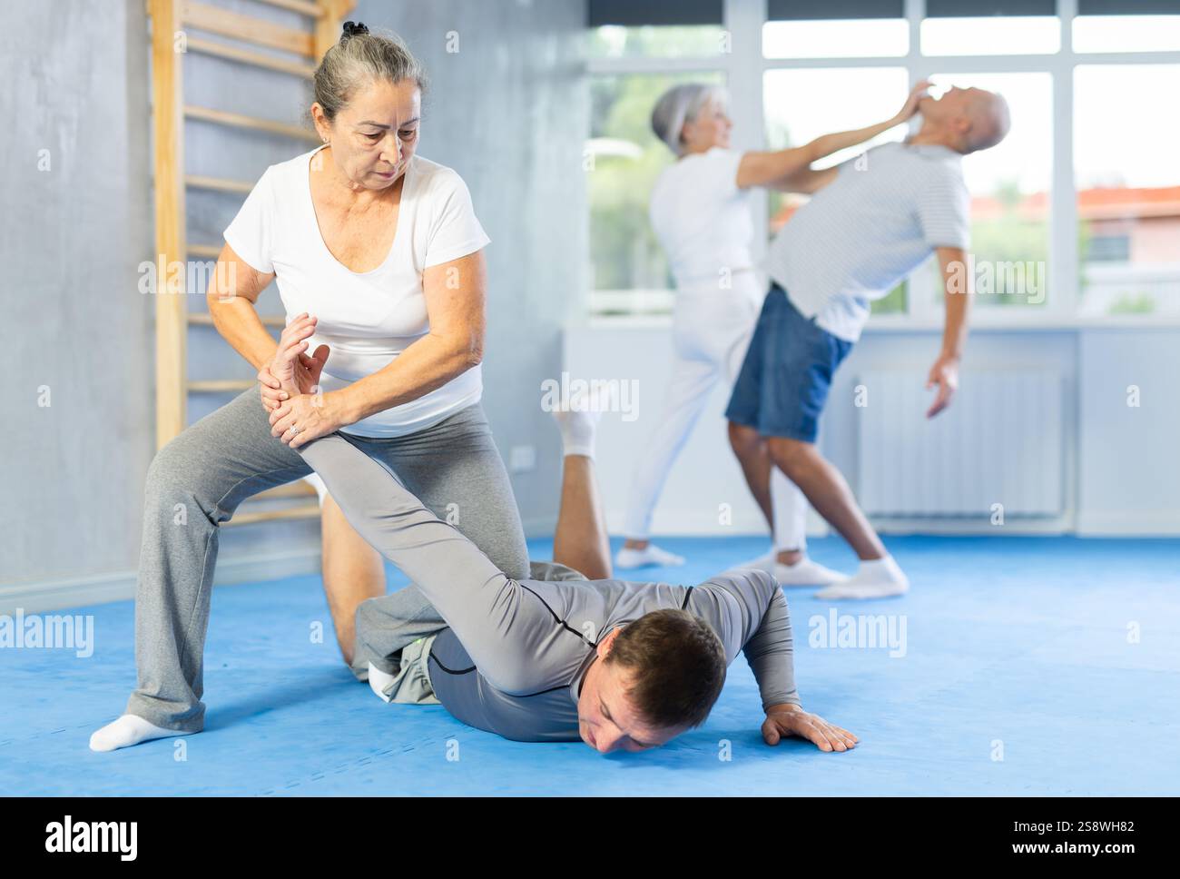Elderly woman twists arm of attacking man with painful hold in gym ...