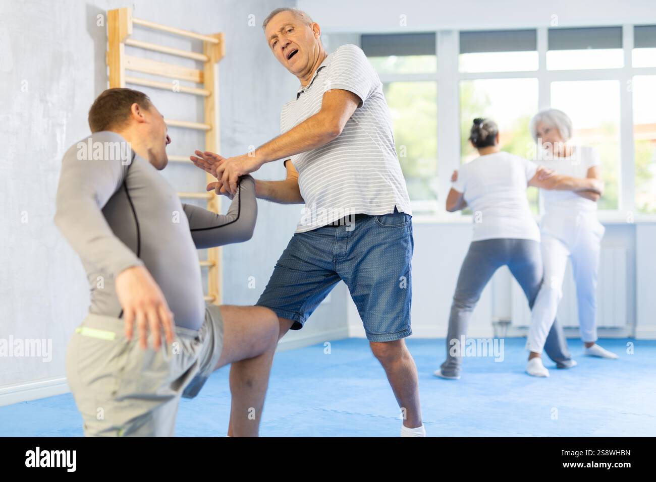 Self defense lesson - elderly man twists the arm of attacking man with ...