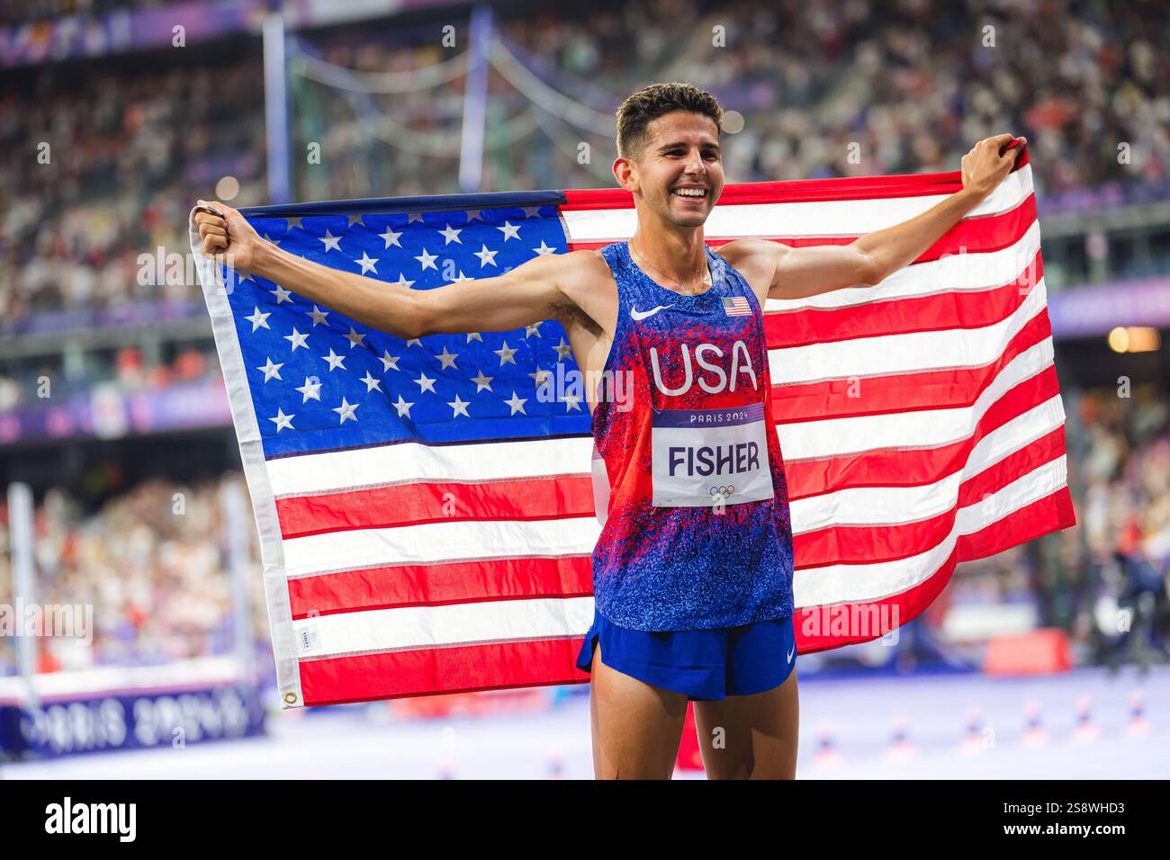 Grant Fisher celebrating her medal with her country's flag at the Paris ...
