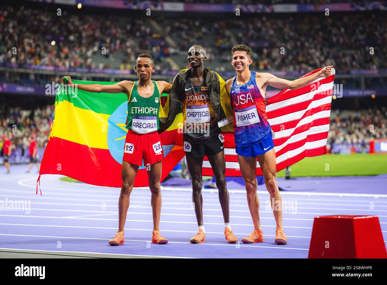 Joshua Cheptegei,Berihu Aregawi and Grant Fisher celebrating her medal ...