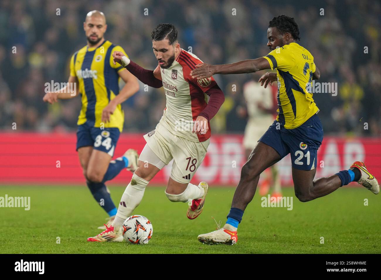 Lyon's Rayan Cherki, center, vies for the ball with Fenerbahce's Bright ...