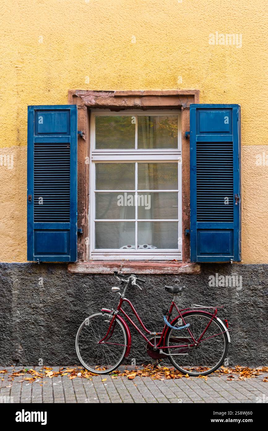 Vintage red bicycle against blue shuttered window Image Stock Photo - Alamy